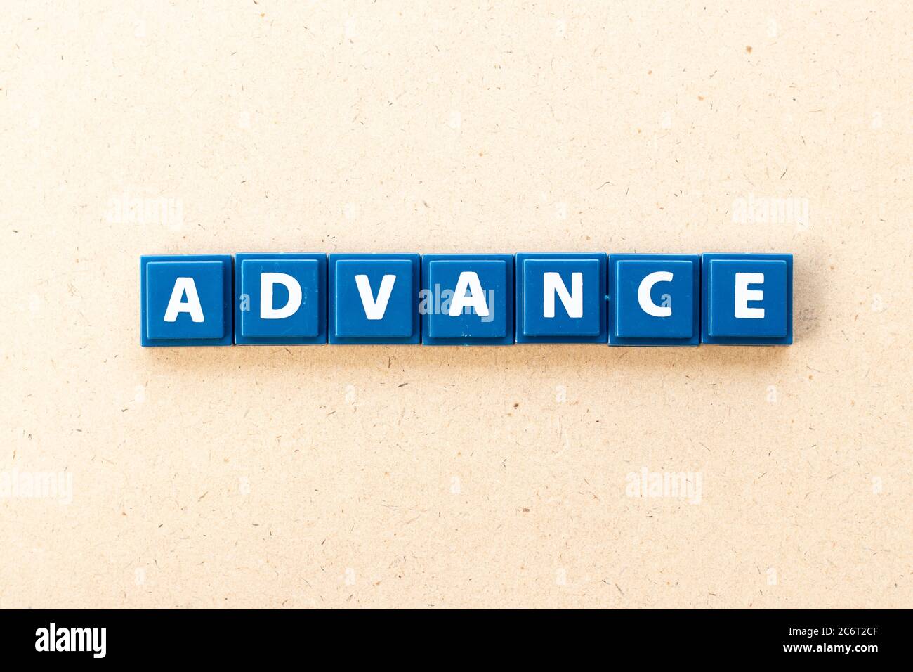 Tile alphabet letter in word advance on wood background Stock Photo - Alamy