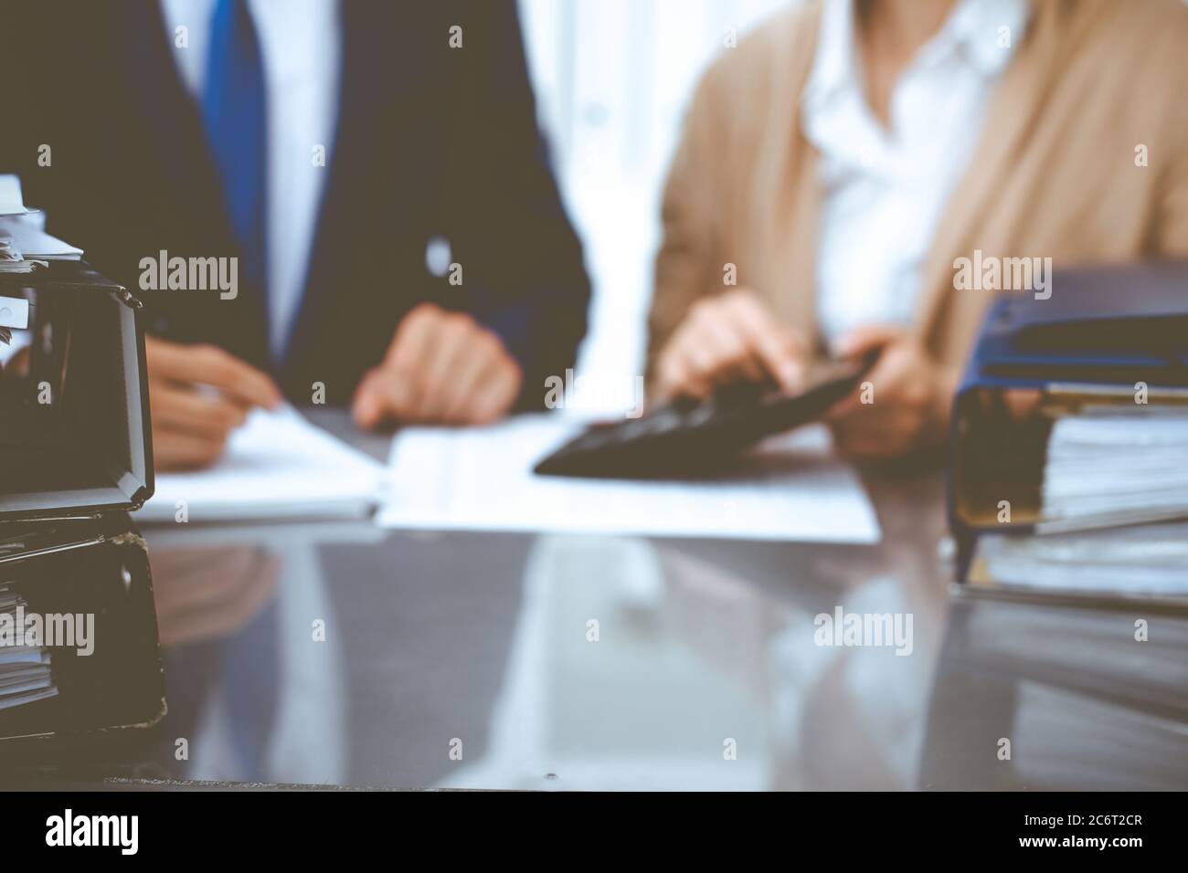Binders with papers waiting to be processed with businessman or ...