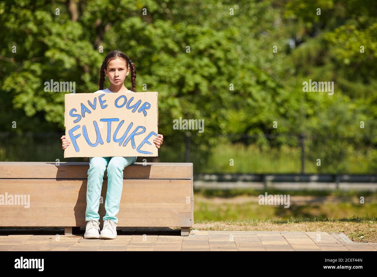 Full length portrait of cute girl holding sign with SAVE FUTURE writing ...