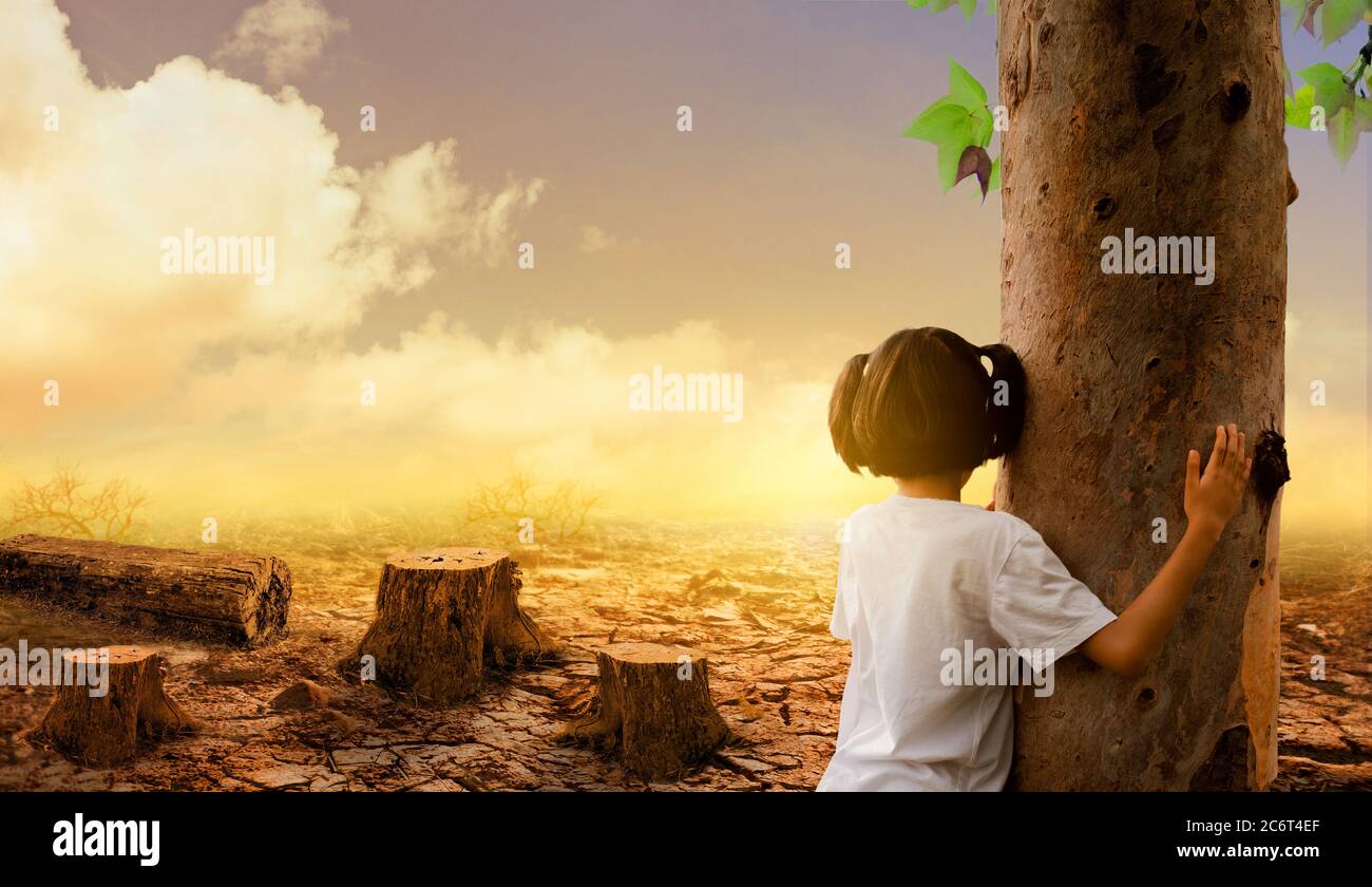 Girl hugging a tree on the cracked earth and dead trees background ...