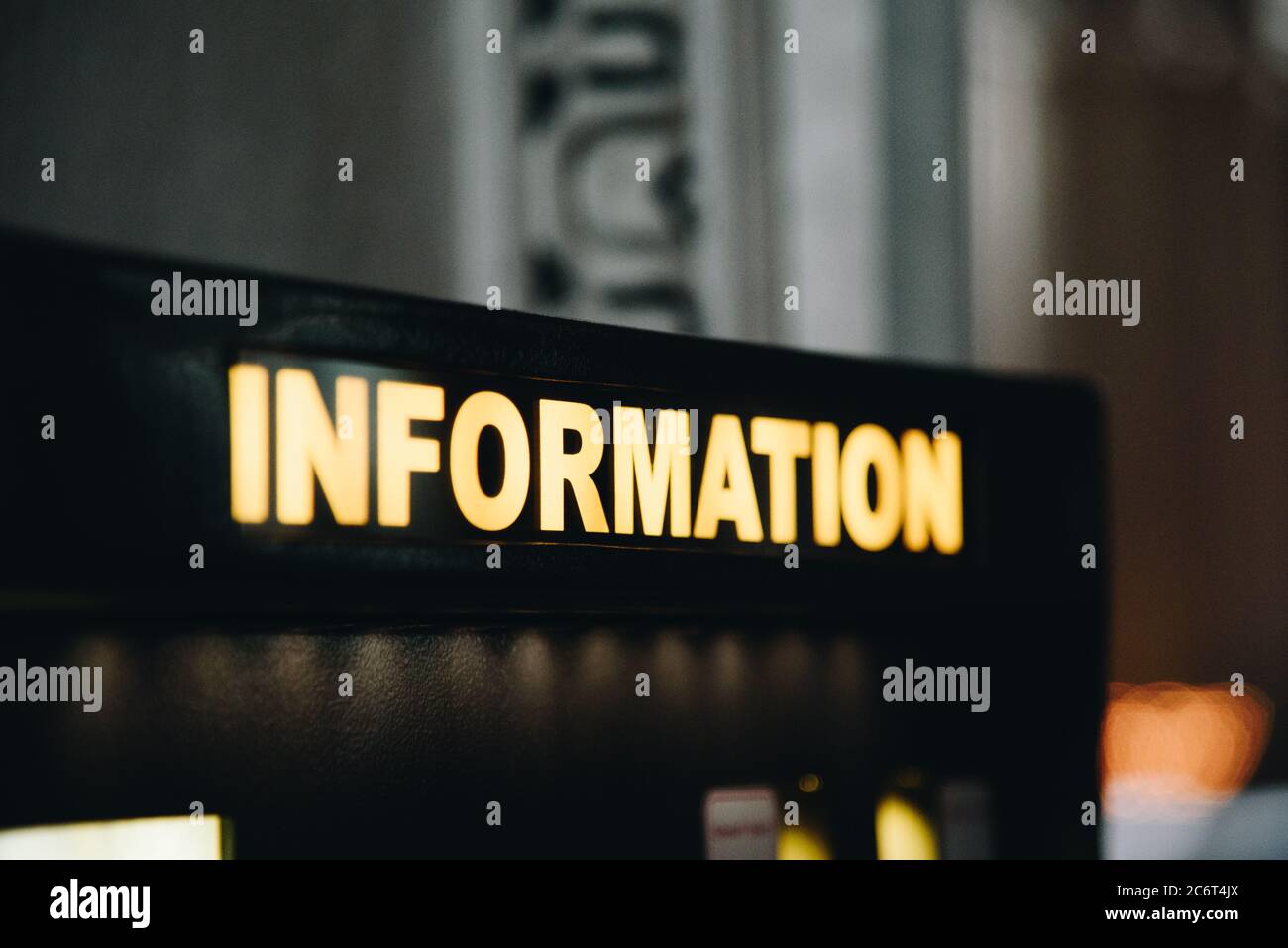 Information sign highlighted with yellow light close up Stock Photo - Alamy
