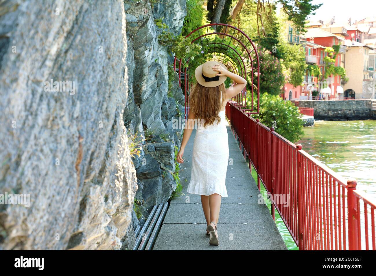Travel in Italy. Back view of tourist girl runs the Walk of Lovers in ...