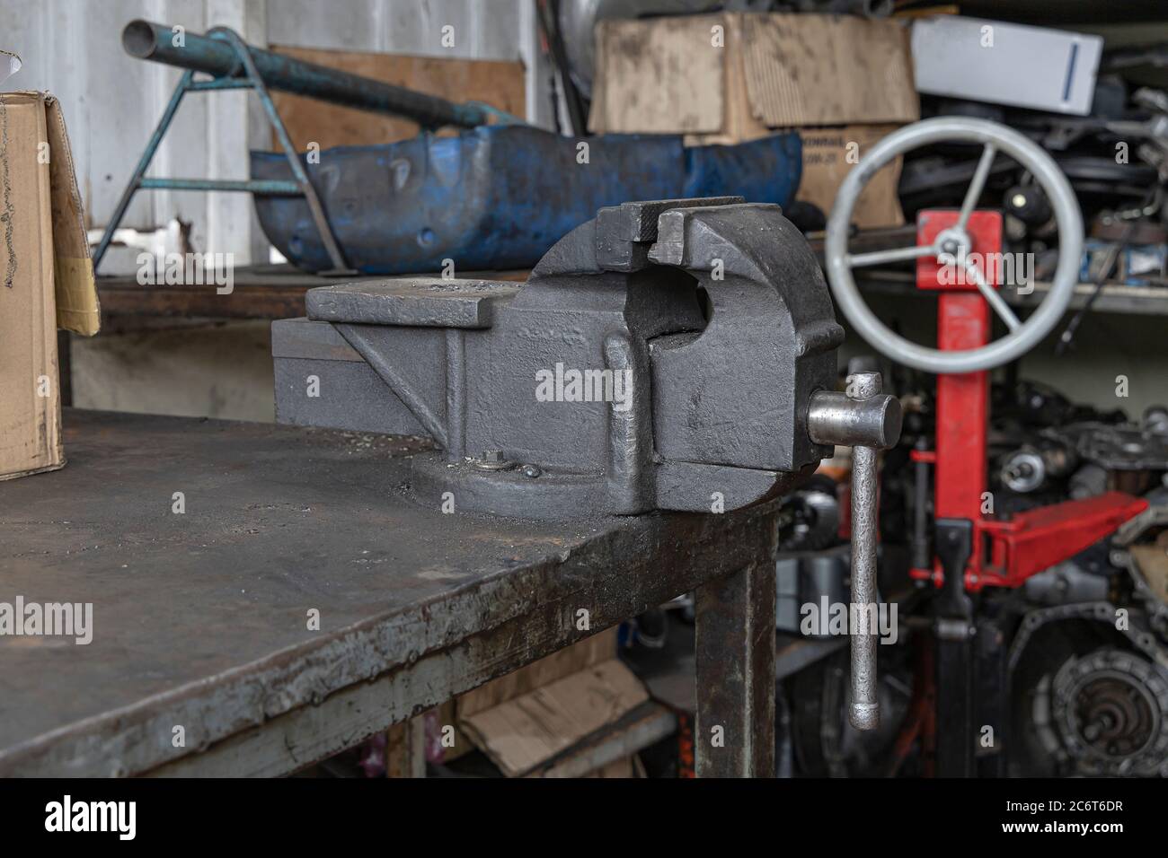 Old metal Bench Vise on steel table at workshop. Metal clamps Stock ...