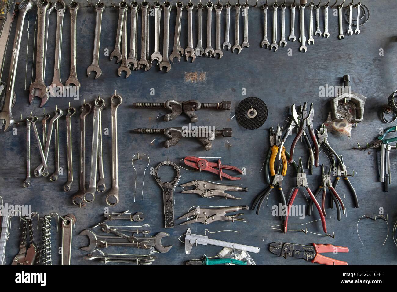 Wrench, Pliers, Clamps. A lot of tools mechanic on old wooden board ...