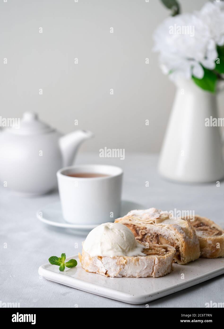 Apple strudel with ice cream and cinnamon. Baked cake and tea ...