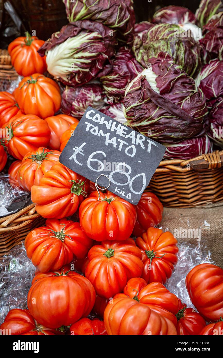 Large cow heart tomatoes for sale on a farmers market stall Stock Photo ...