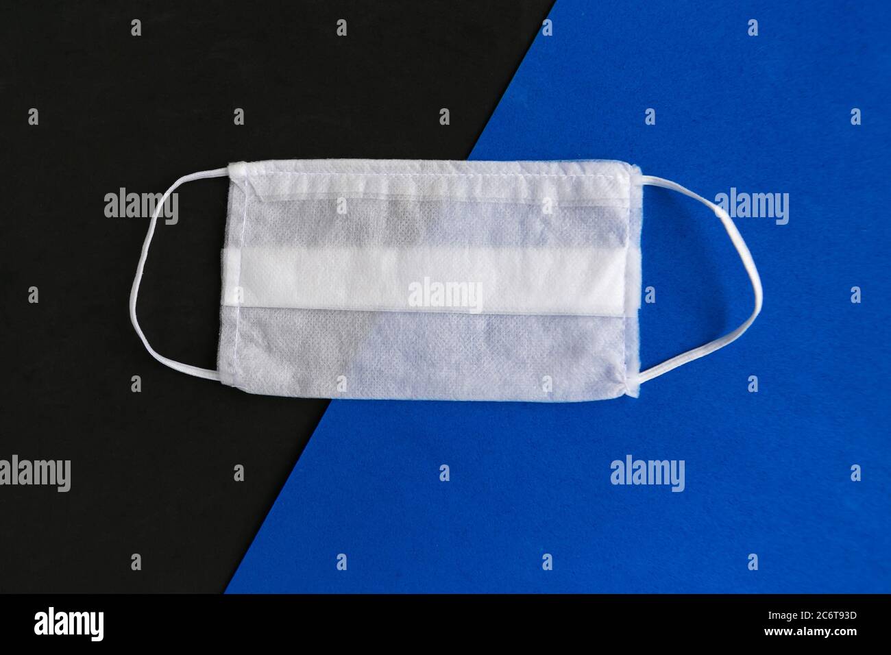 Medical mask on geometric blue and black background, minimal concept ...