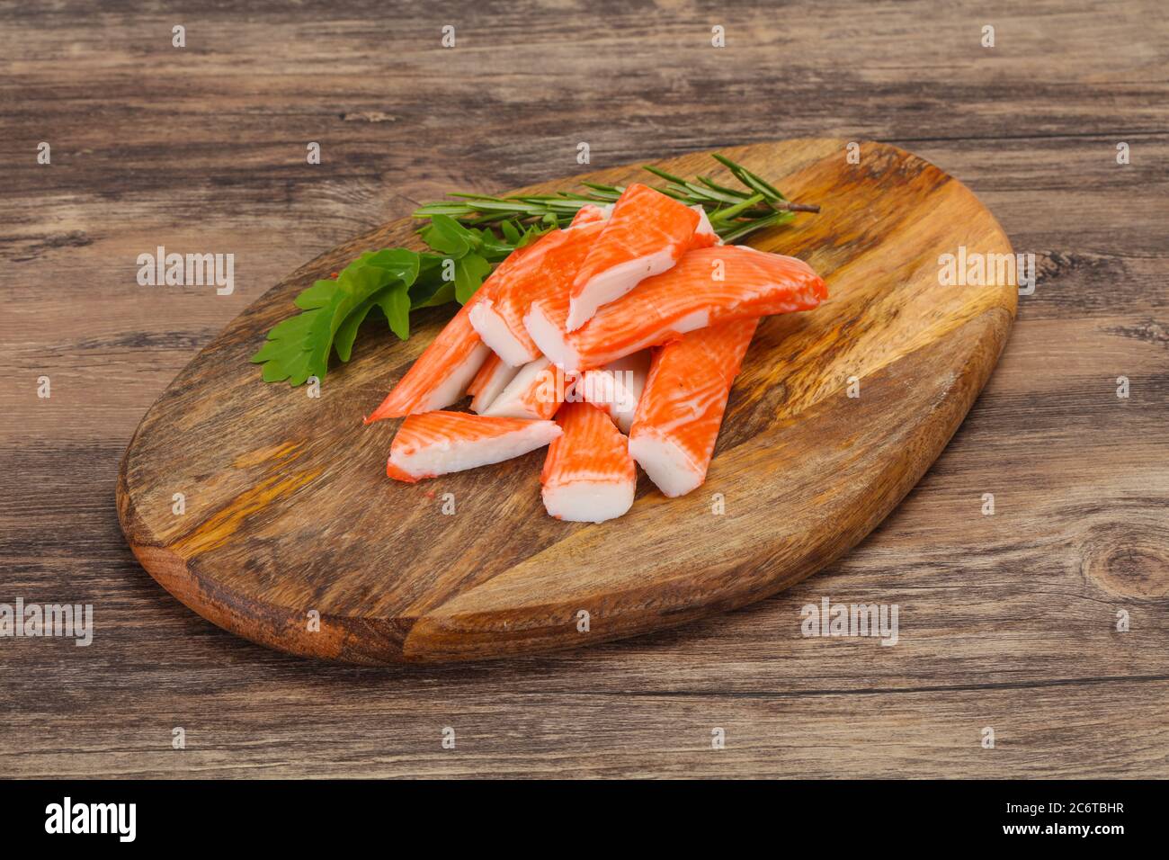 Crab stick surimi over wooden board Stock Photo - Alamy