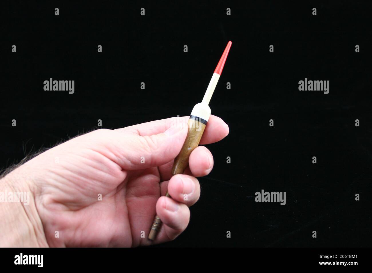 Old man's hand holding fishing lure with black background Stock Photo ...