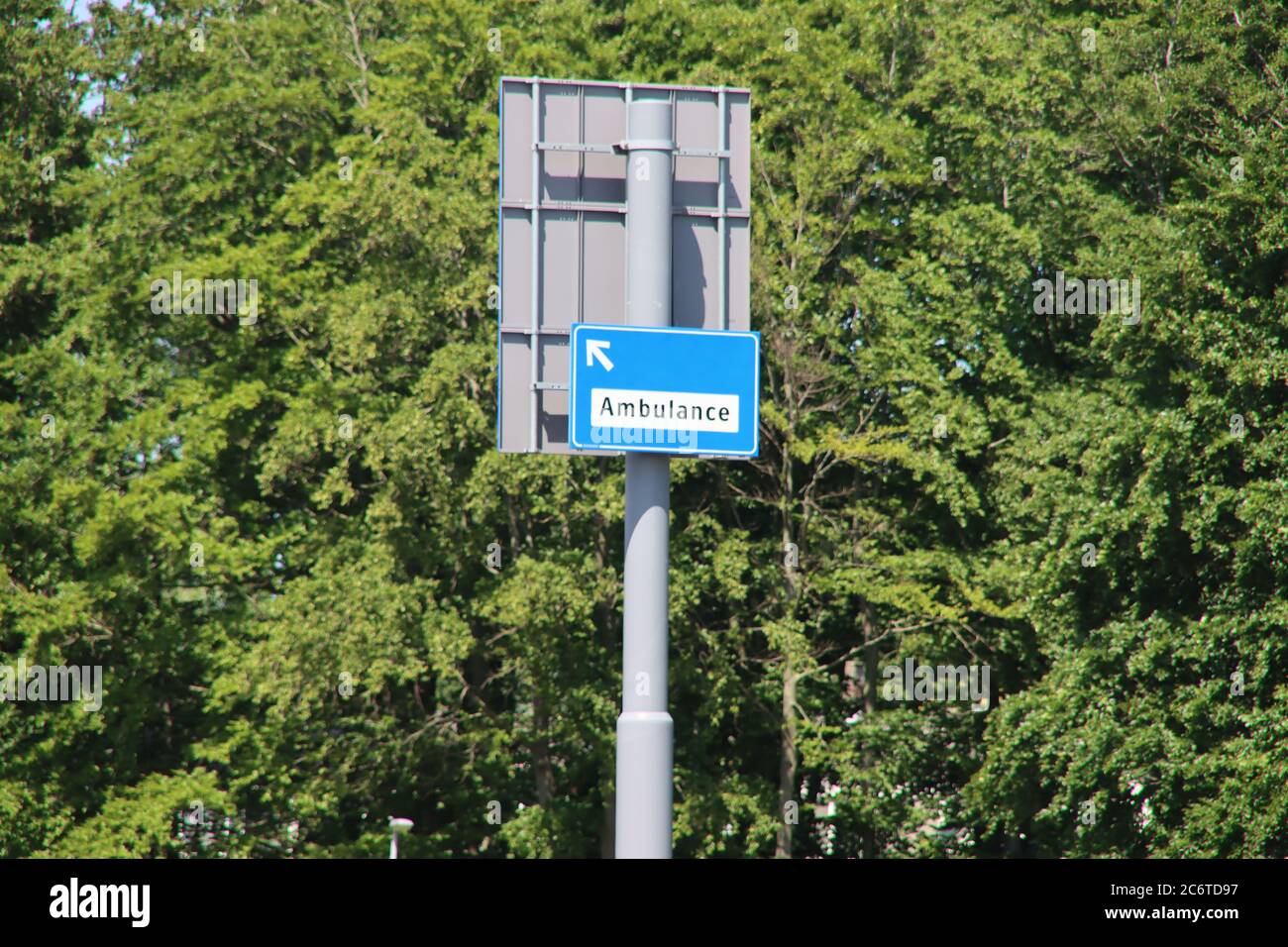 Direction sign in Blue and white heading the Emergency route for ...