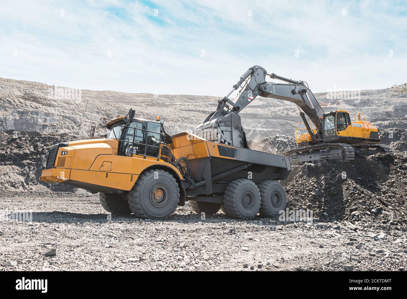 Large quarry dump truck. Loading the rock in dumper. Loading coal into body truck. Production ...