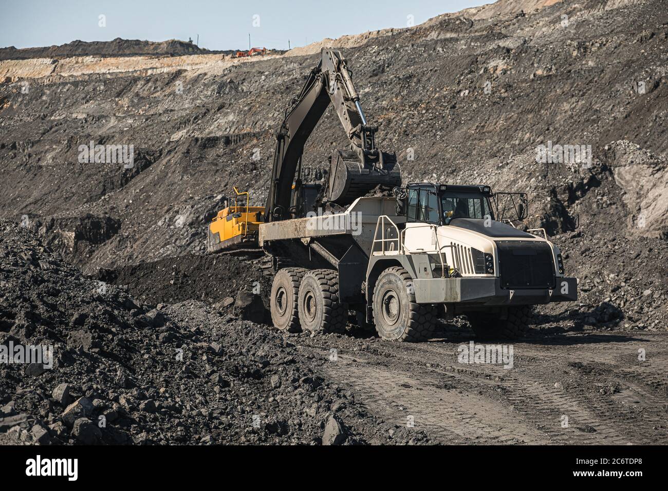 Large quarry dump truck. Loading the rock in dumper. Loading coal into body truck. Production ...