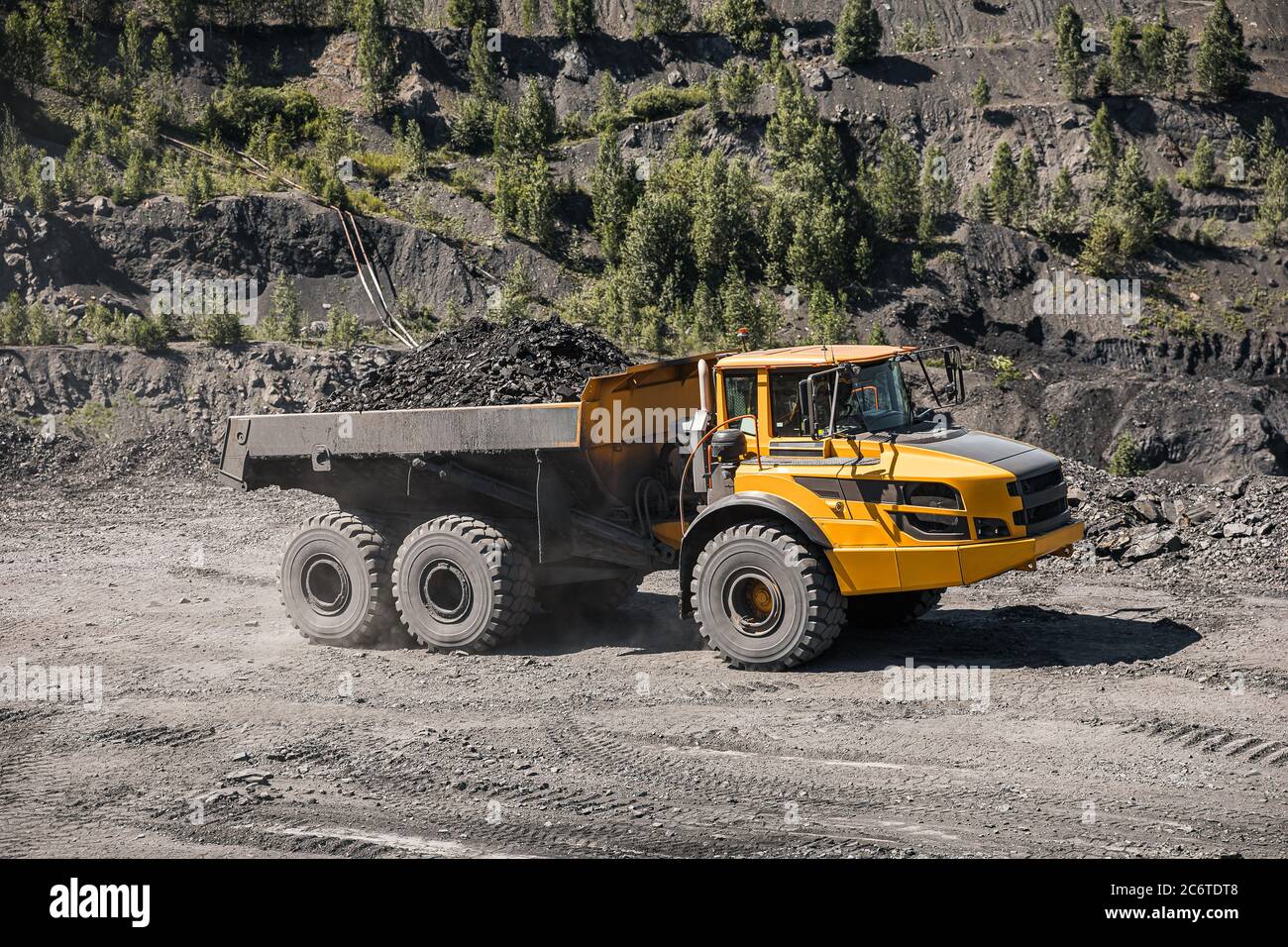 Large quarry dump truck. Loading the rock in dumper. Loading coal into body truck. Production ...