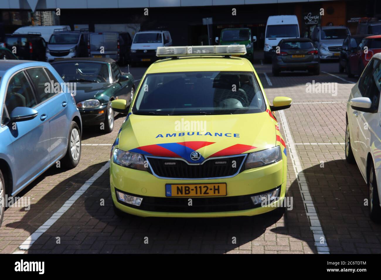 Medical emergency vehicles in yellow color on the street of Rotterdam ...