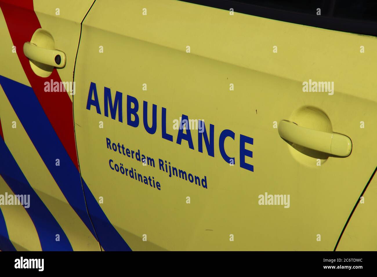 Medical emergency vehicles in yellow color on the street of Rotterdam ...