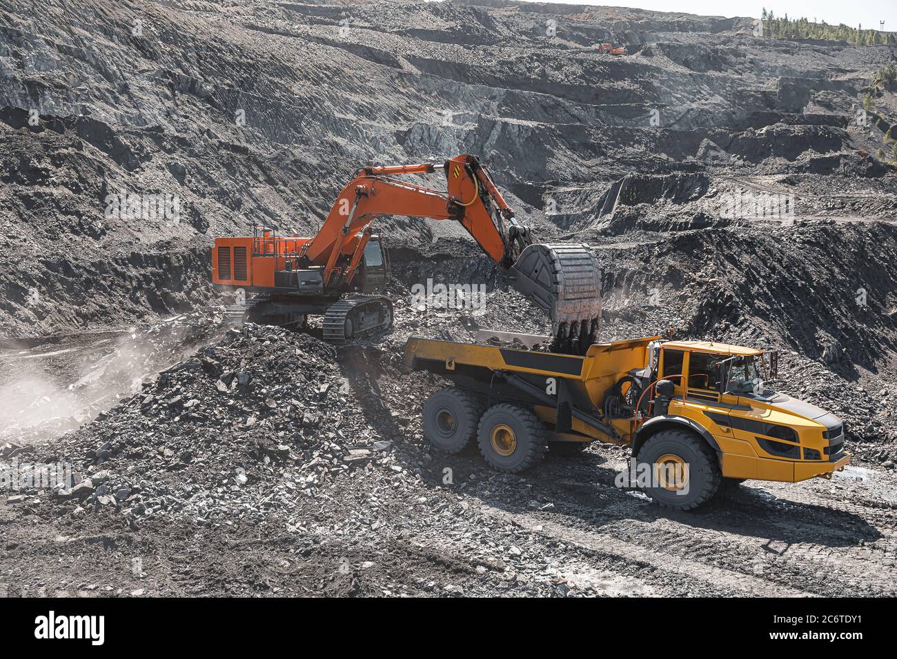 Large quarry dump truck. Loading the rock in dumper. Loading coal into body truck. Production ...