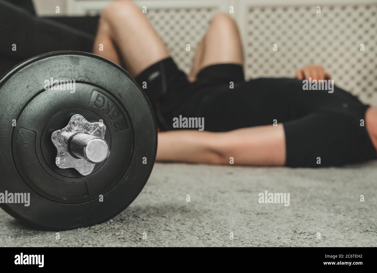 Man resting between exercise sets. Home fitness training concept Stock ...