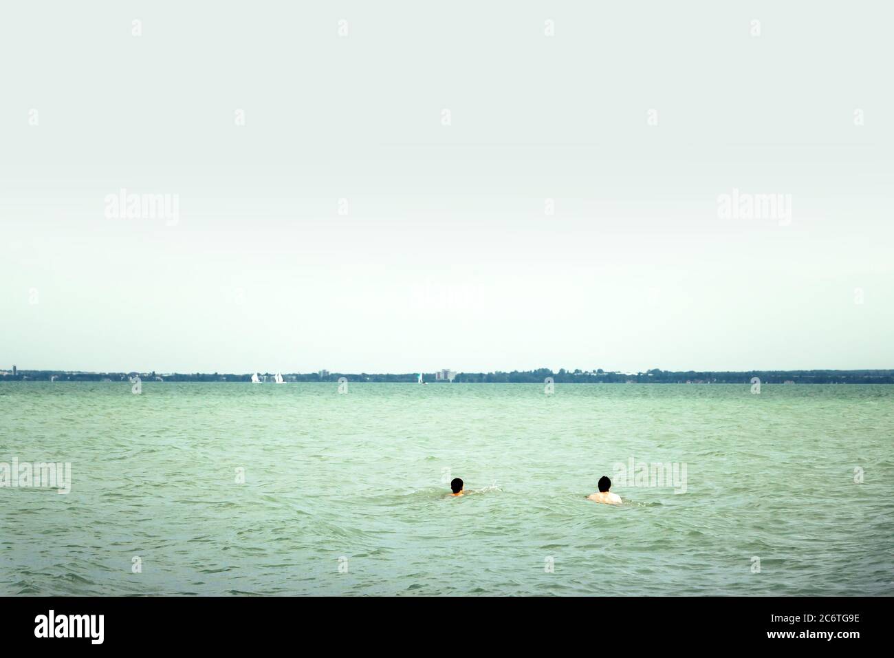 Panoramic view of the Lake Balaton with two swimmwers. Balaton is the ...