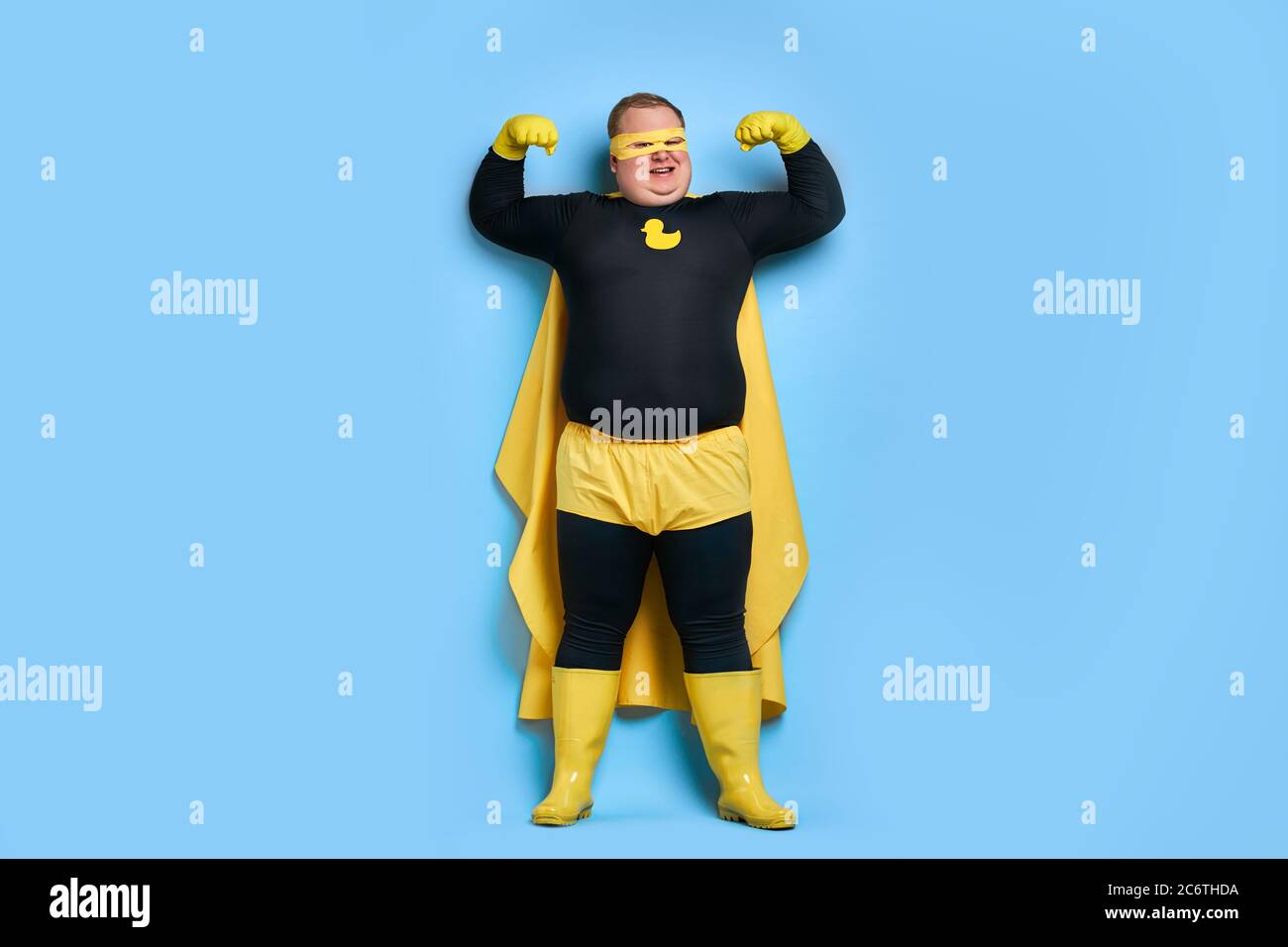 strong fat caucasian superhero man shows his muscles at camera, young ...