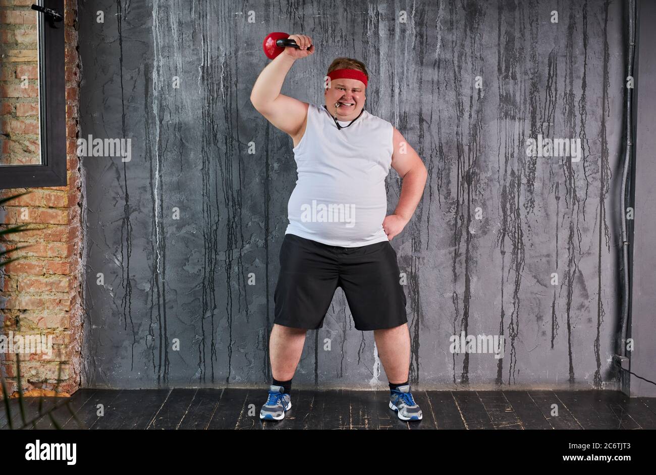 fat caucasian strong male shows his competence with the use of ...