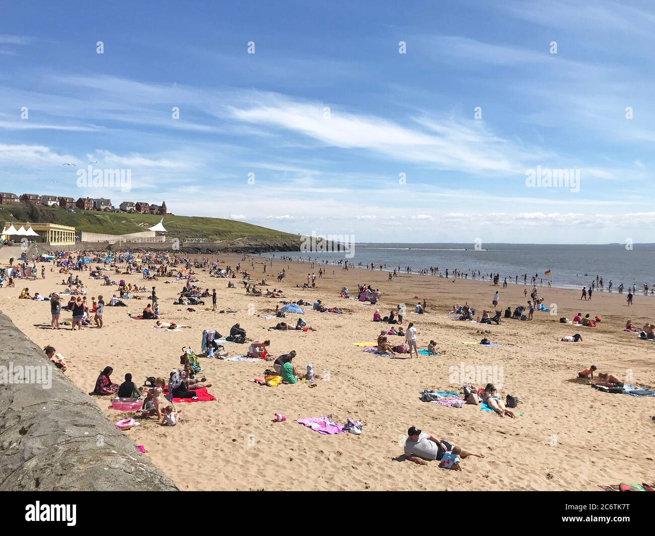 People enjoy the sunshine and warm weather on Whitmore Bay beach in ...