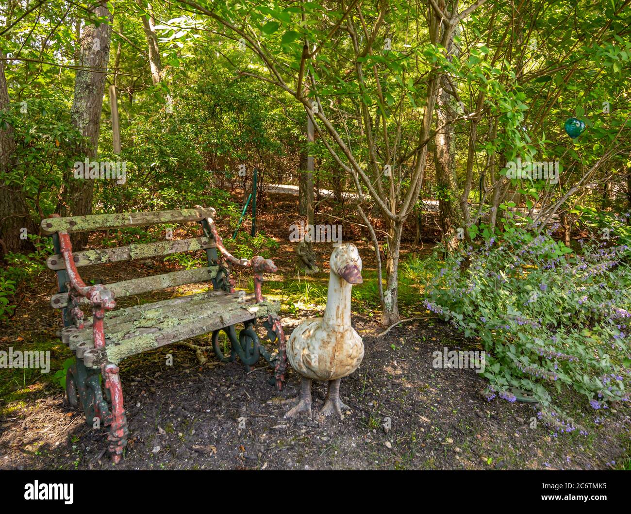 Antique duck sculpture and weathered park bench Stock Photo - Alamy