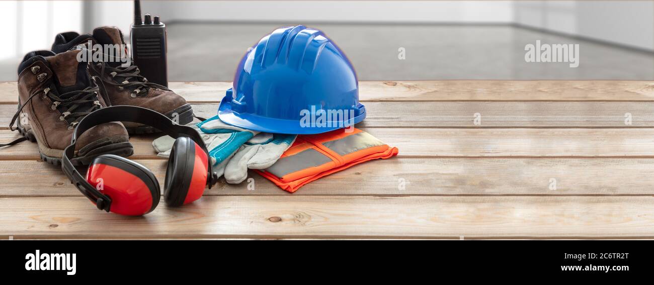 Work safety protection equipment. Industrial protective gear on wooden ...