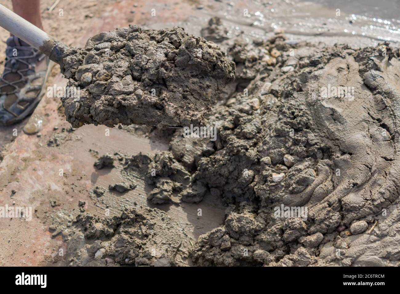 worker mixing concrete and gravel with spade on construction cite Stock ...