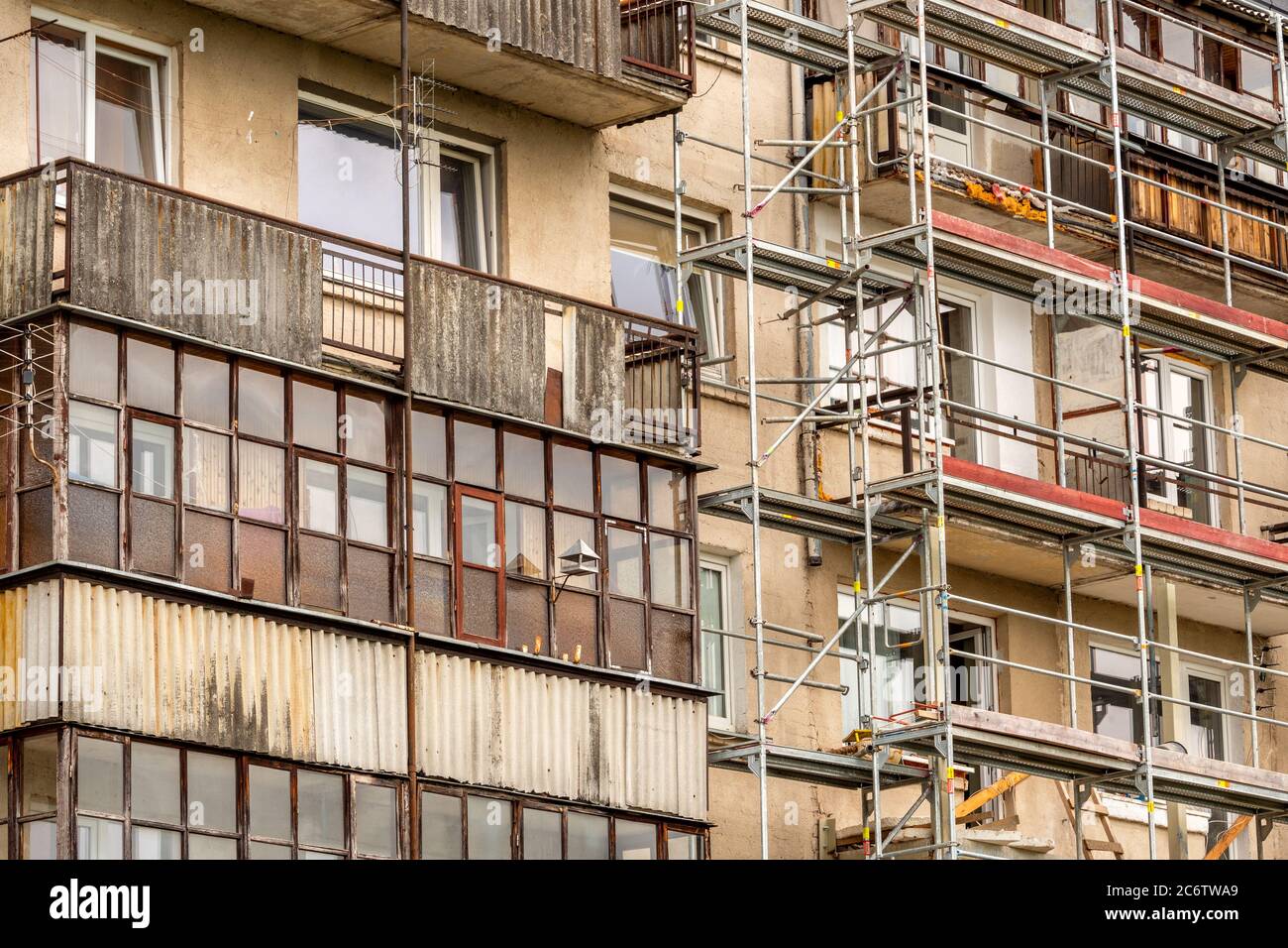 Scaffolding standing against the wall of multistorey building ...
