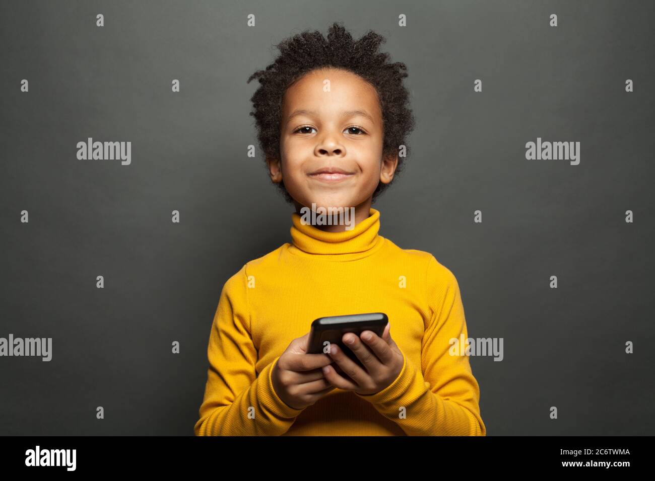 Happy smiling black child boy with smartphone Stock Photo - Alamy