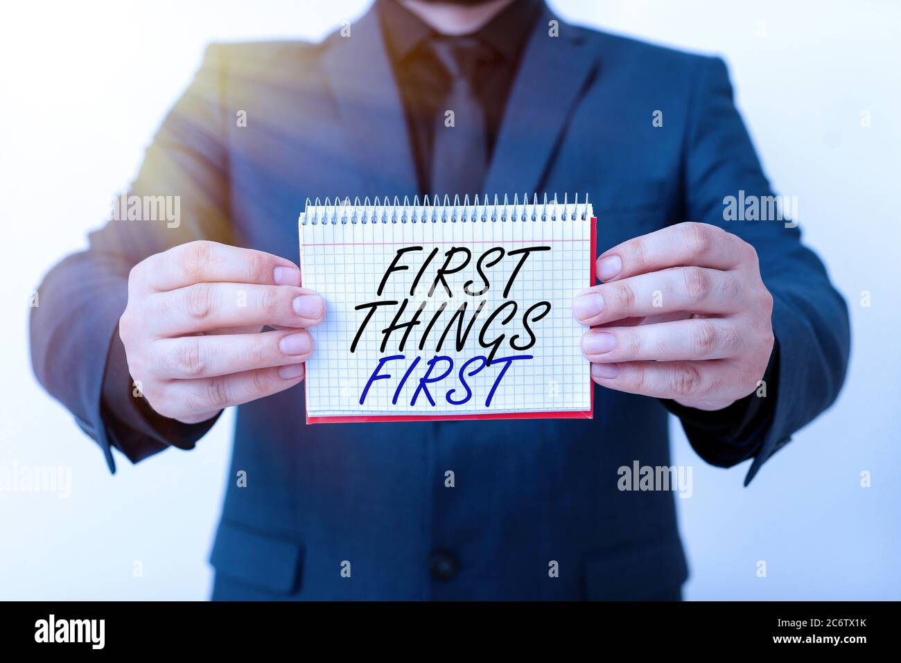 Writing note showing First Things First. Business concept for Business ...