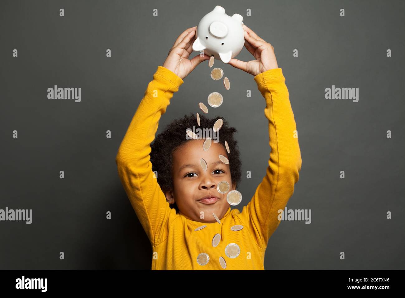 Happy black child and money rain on black background Stock Photo - Alamy