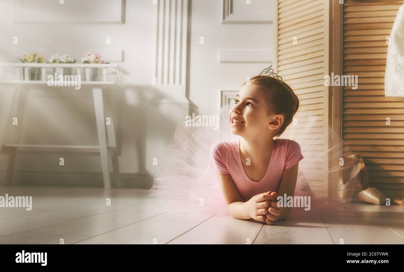 Cute little girl dreams of becoming a ballerina. Child girl in a pink ...