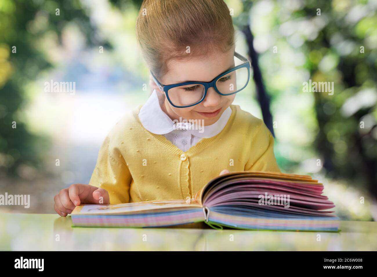 small beautiful child reading a book Stock Photo - Alamy