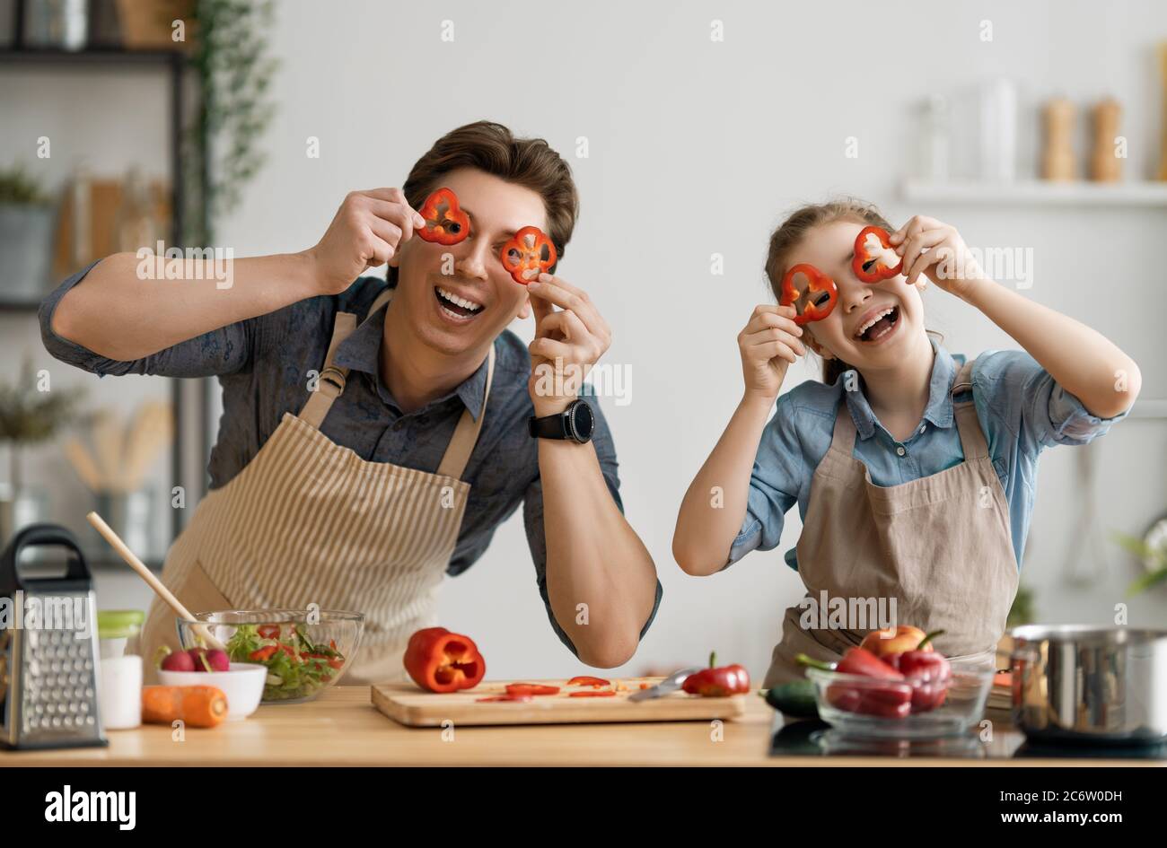 Healthy food at home. Happy family in the kitchen. Father and child ...