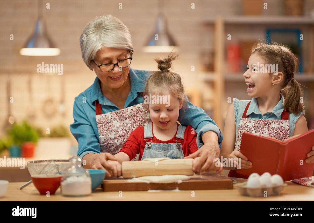 Happy loving family are preparing bakery together. Granny and children ...