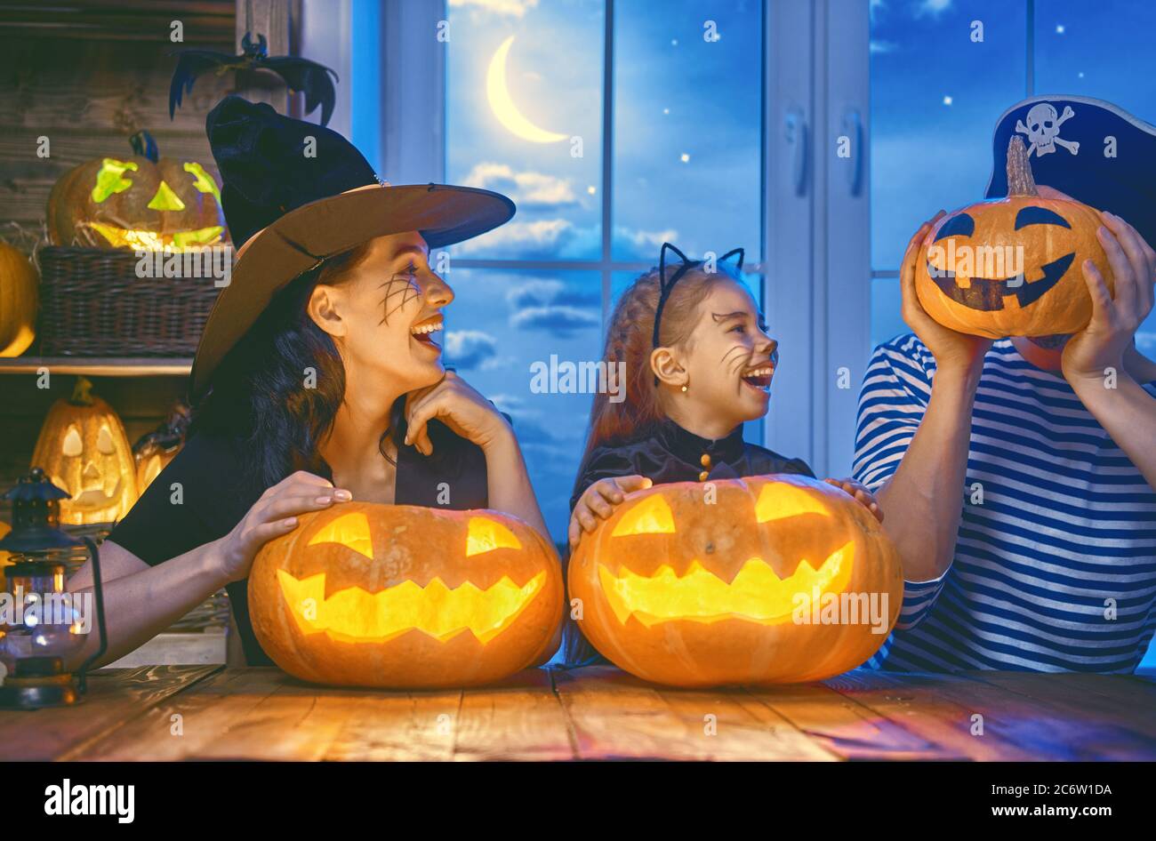 Mother, father and their daughter having fun at home. Happy family ...