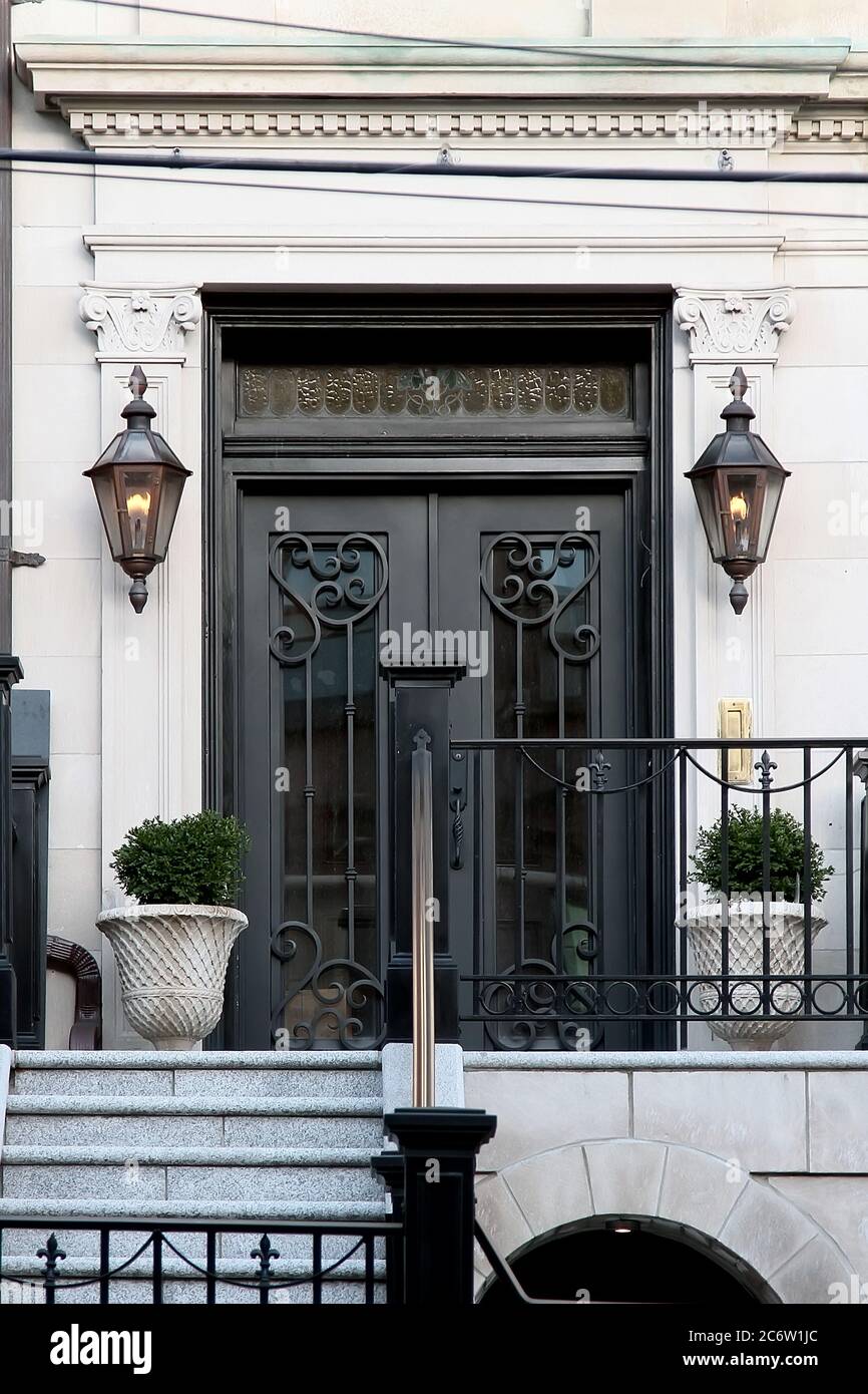 Vintage black double door with lanterns, flower pots and decorative ...