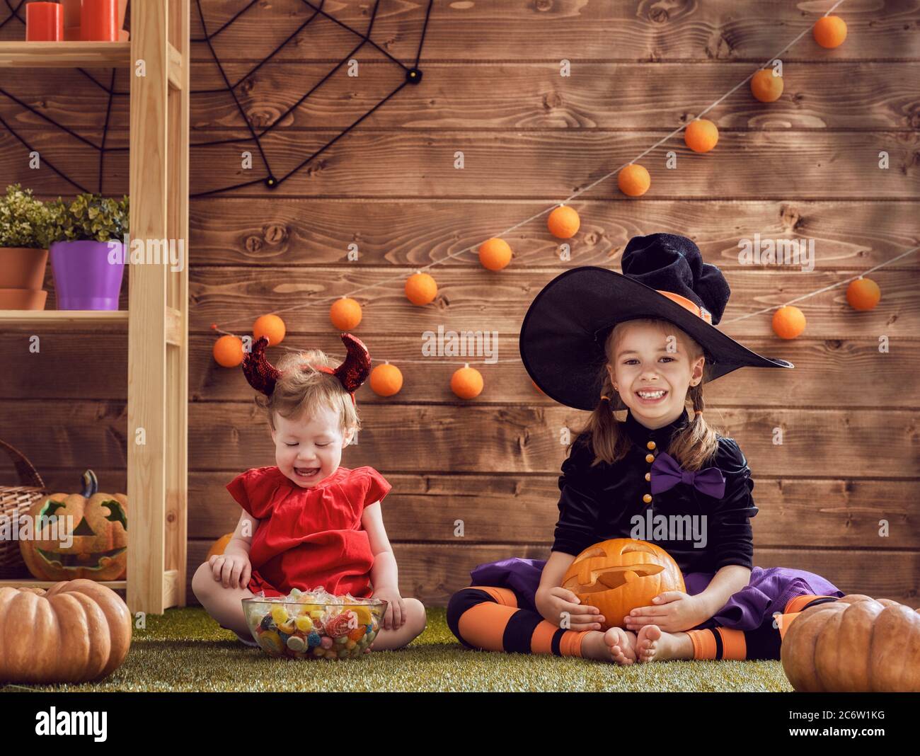 Two cute funny sisters celebrate the holiday. Jolly children in ...