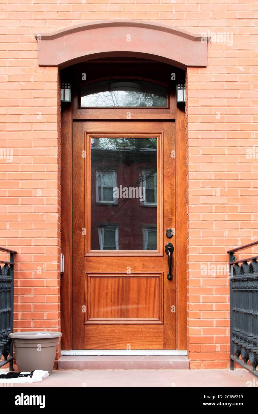 Wooden vintage entry door decorated with arch. New York. USA Stock ...