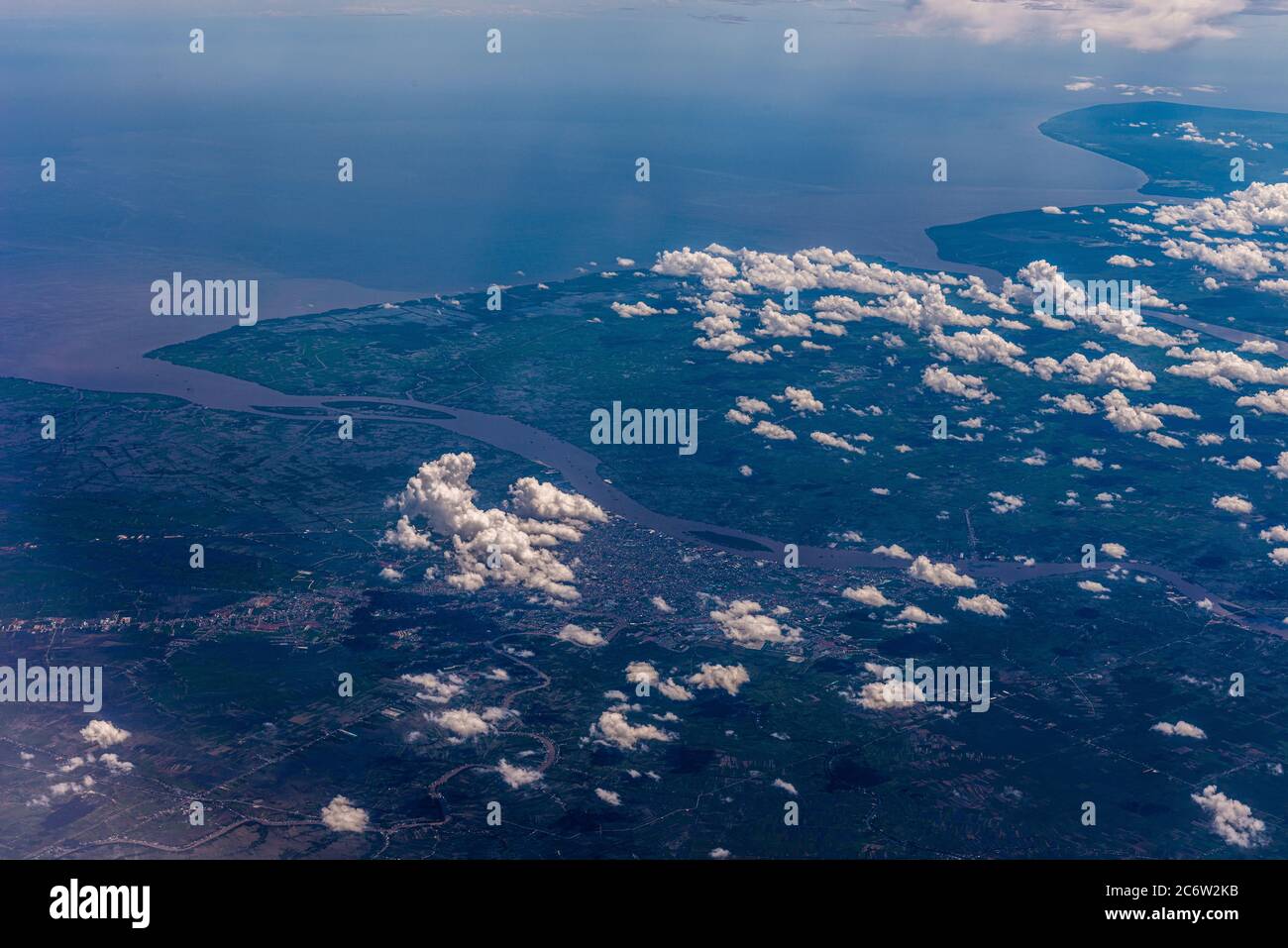 Flying through clouds over island hi-res stock photography and images ...
