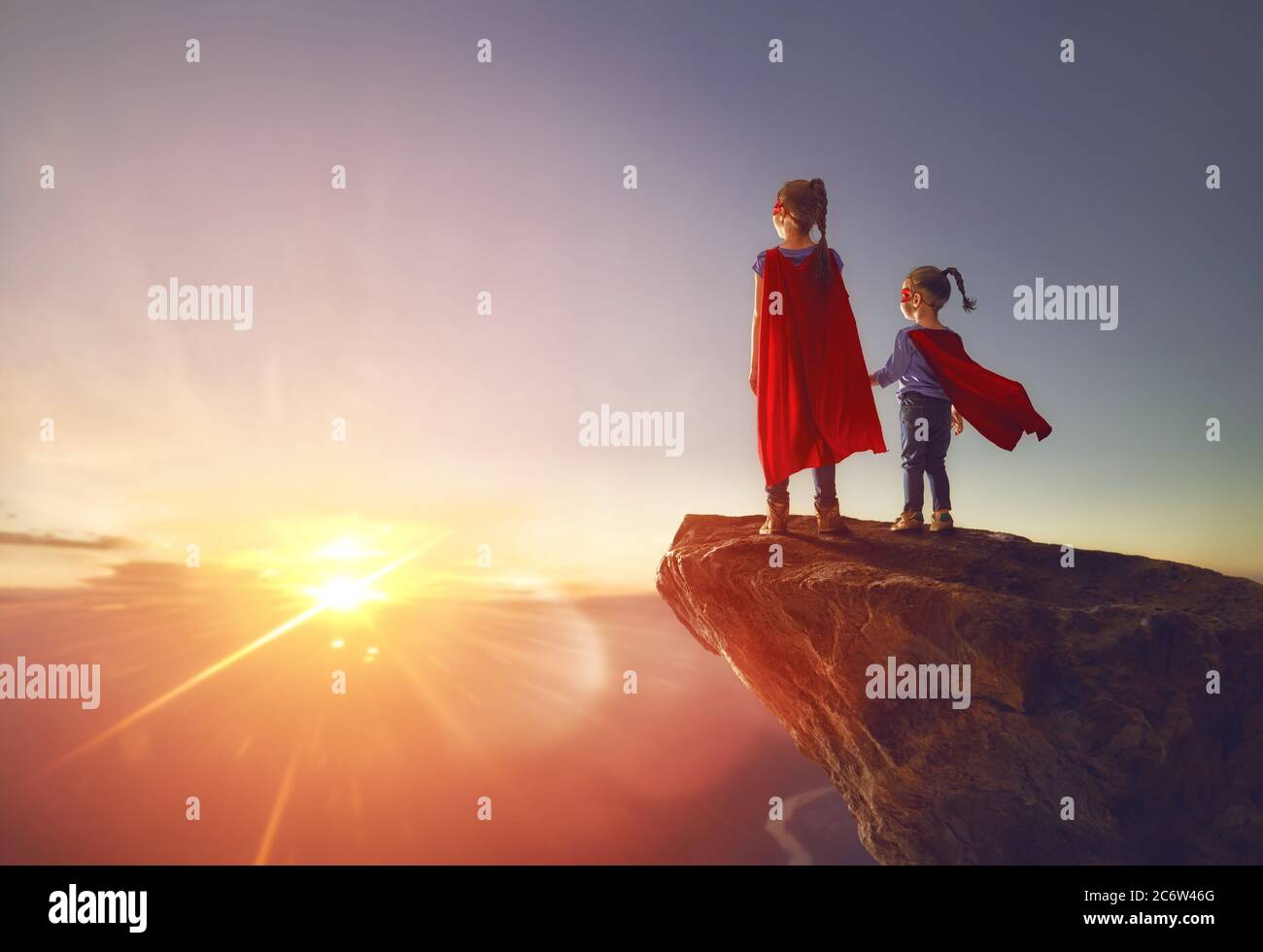 Two little children are playing superhero. Kids on the background of ...