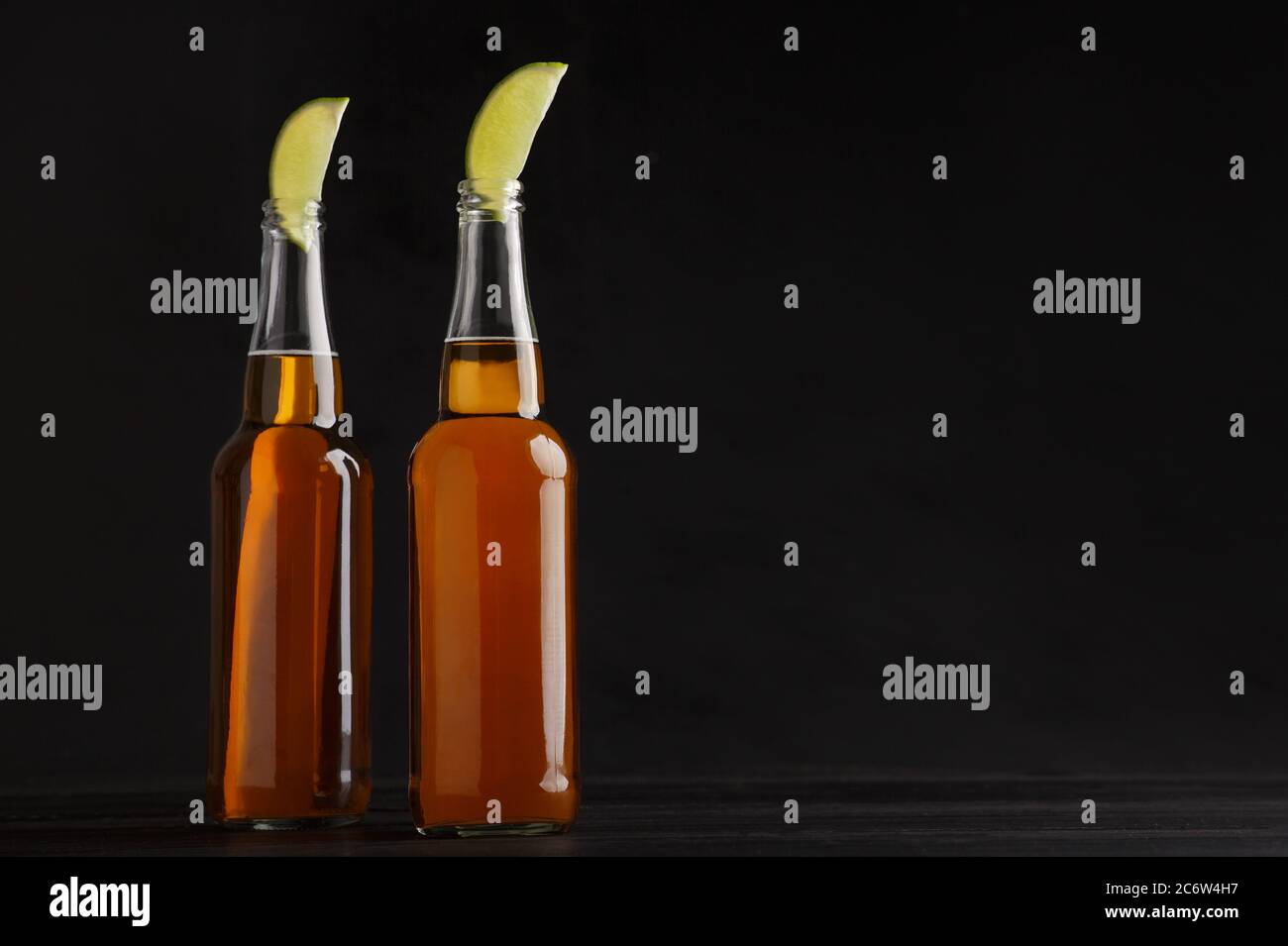 Beer order. Bottles with lager and slices of lime isolated on black ...