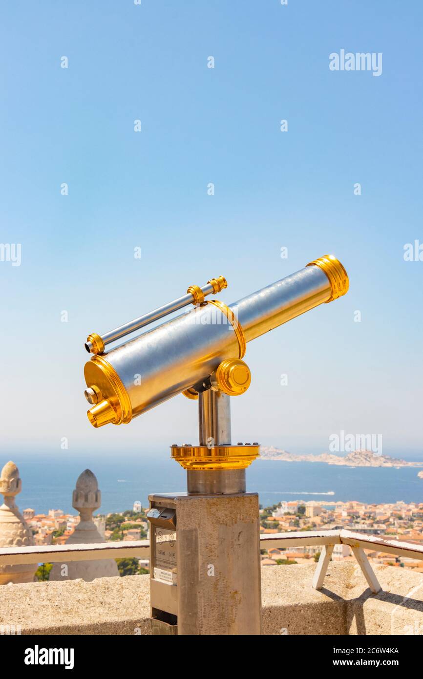 isolated brass tourist telescope at Basilique Notre-Dame de la Garde In ...