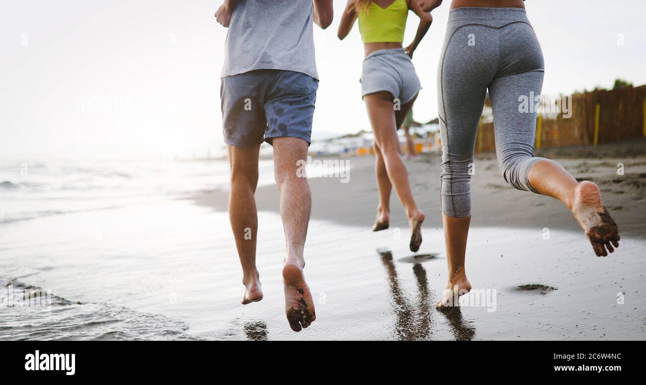 Group running into sea hi-res stock photography and images - Alamy