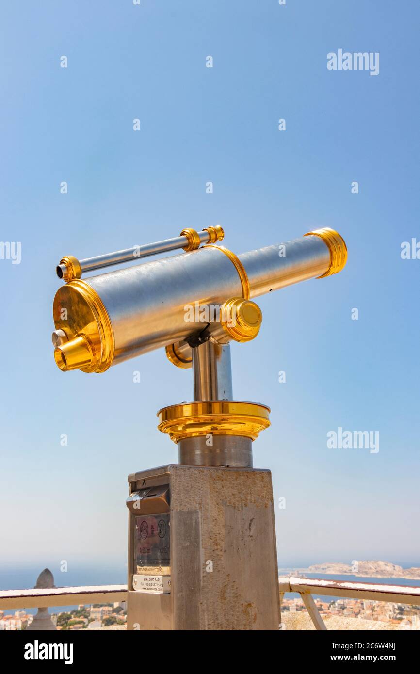 isolated brass tourist telescope at Basilique Notre-Dame de la Garde In ...