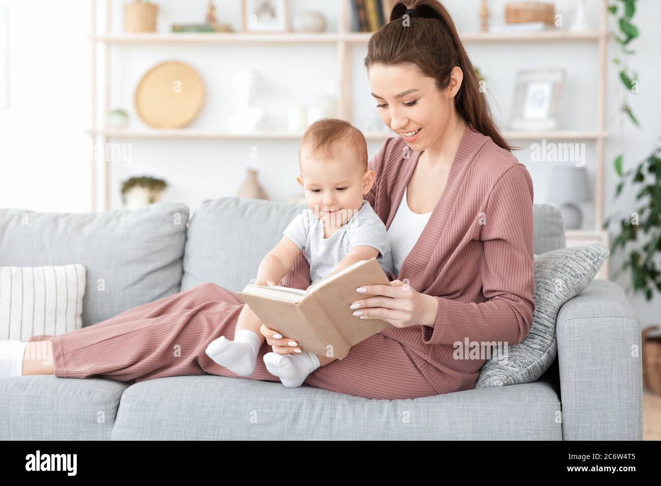 Best Baby Books. Loving Mom Reading To Her Toddler Son At Home Stock ...