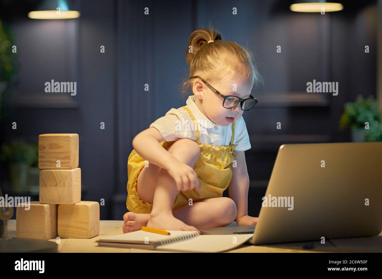 Cute baby girl working on a computer at home Stock Photo - Alamy