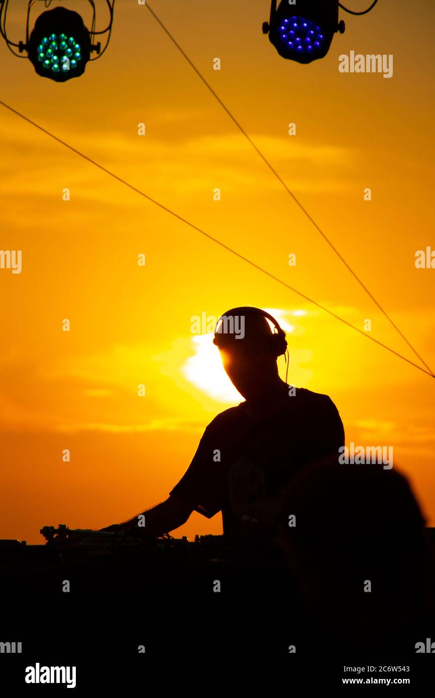 silhouette of DJ against sunset sky at rooftop party In Marseille ...