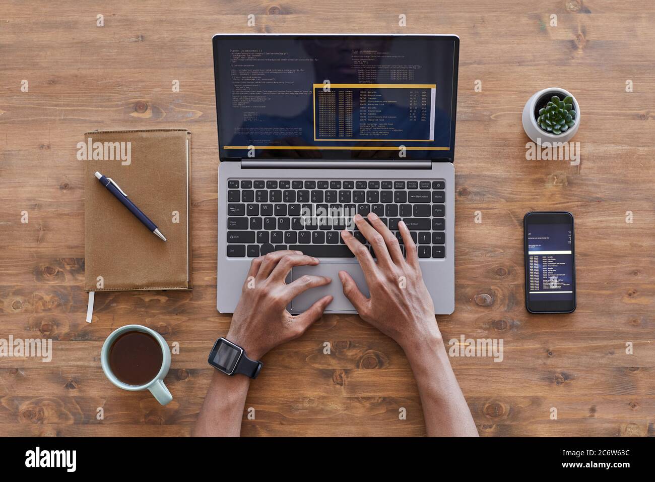 Top down view at male hands typing on laptop keyboard while writing ...